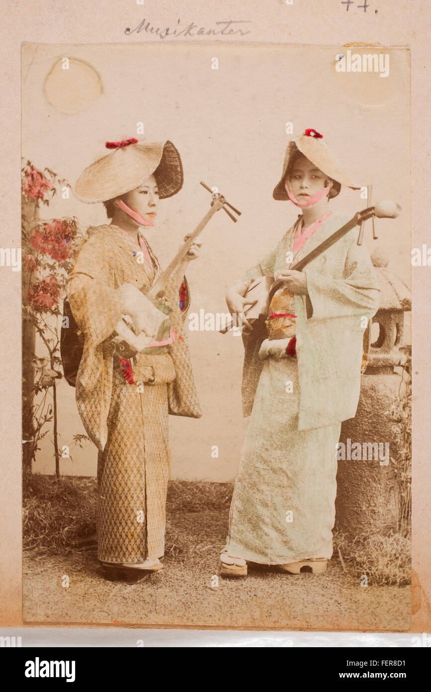 A postcard showing geishas in Japan playing traditional instruments ...