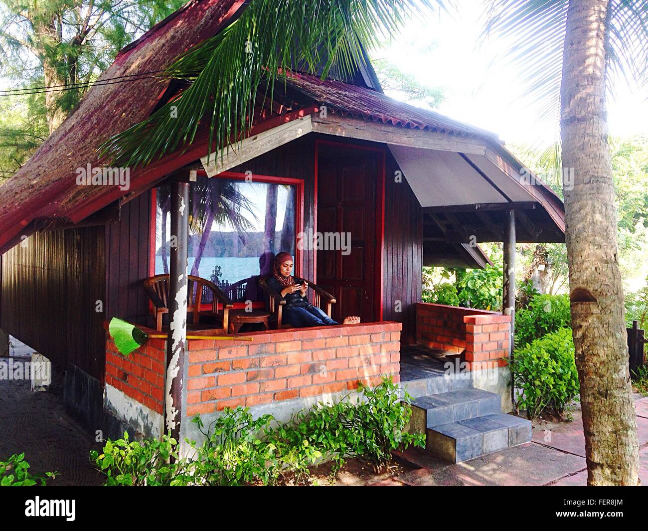 Woman sitting in log cabin hi-res stock photography and images - Alamy