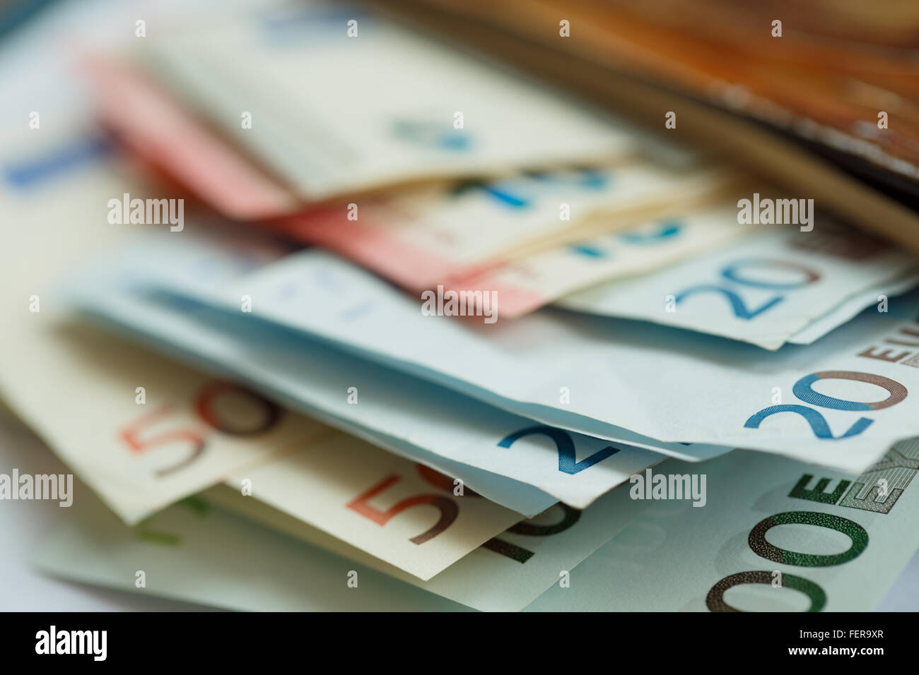 Brown leather wallet with money euro inside it Stock Photo - Alamy
