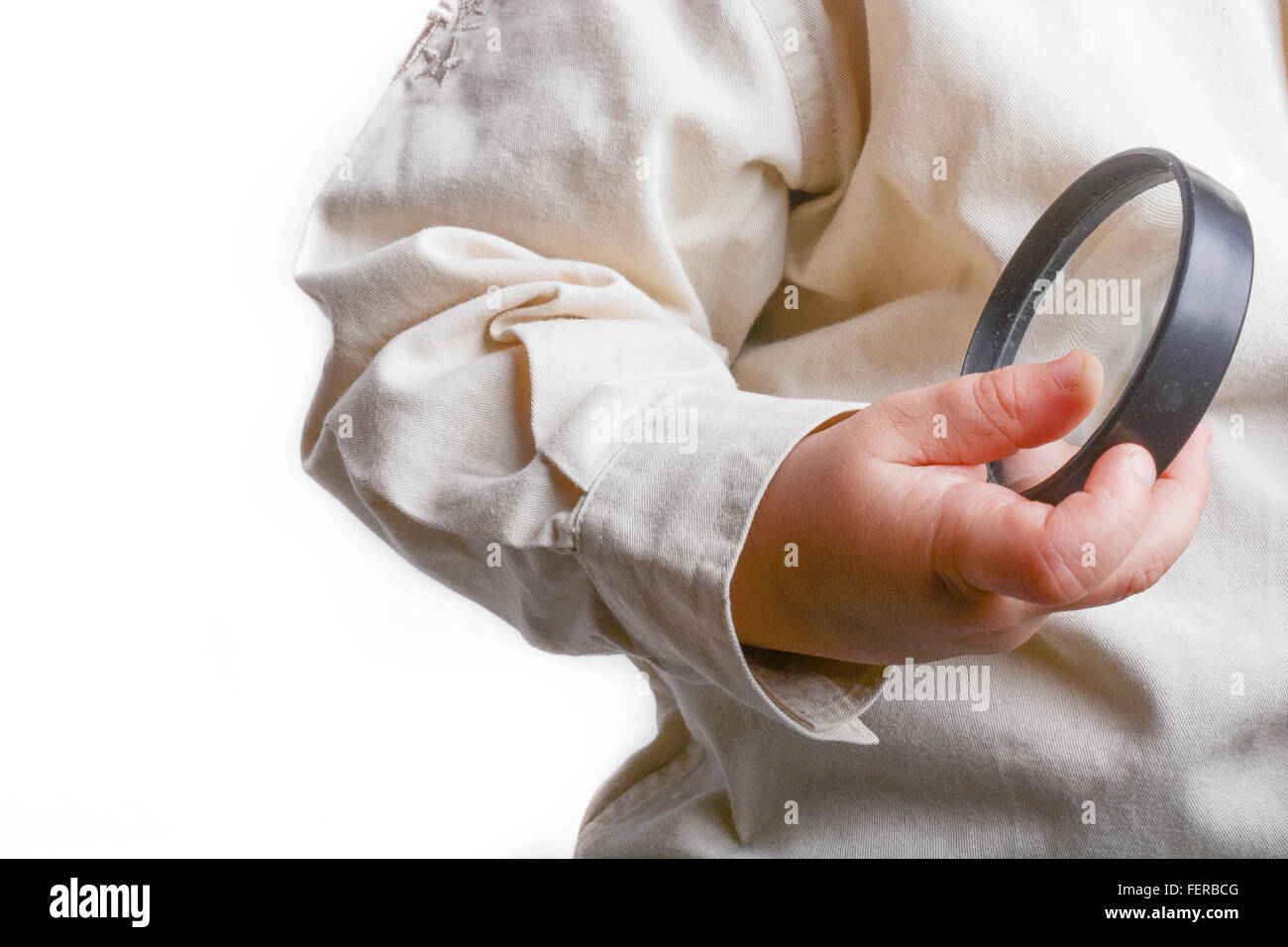 Baby holding a magnifying glass in hand on a white background Stock ...