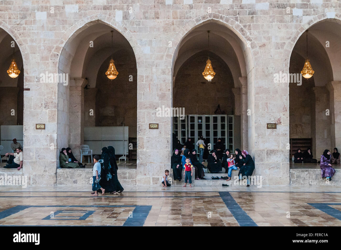People Relaxing On Steps Of Arch Building Stock Photo - Alamy