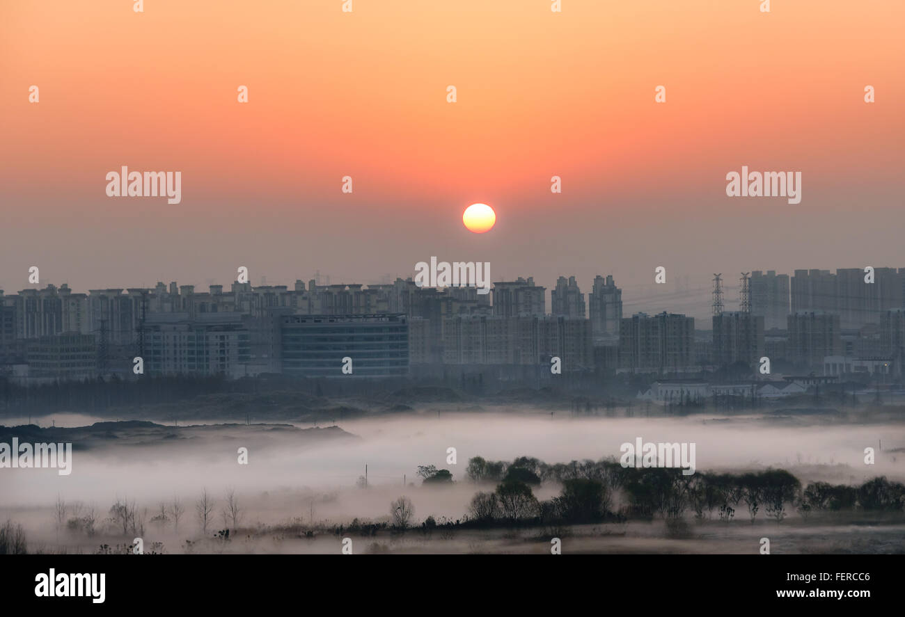 Sun rising behind the block of apartment in Shanghai, China Stock Photo ...