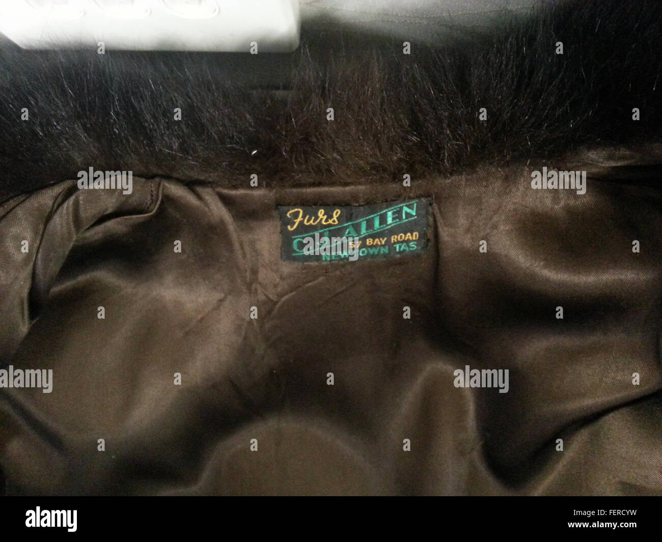 A close-up photograph of the label on a fur coat made by C. J. Allen, a ...