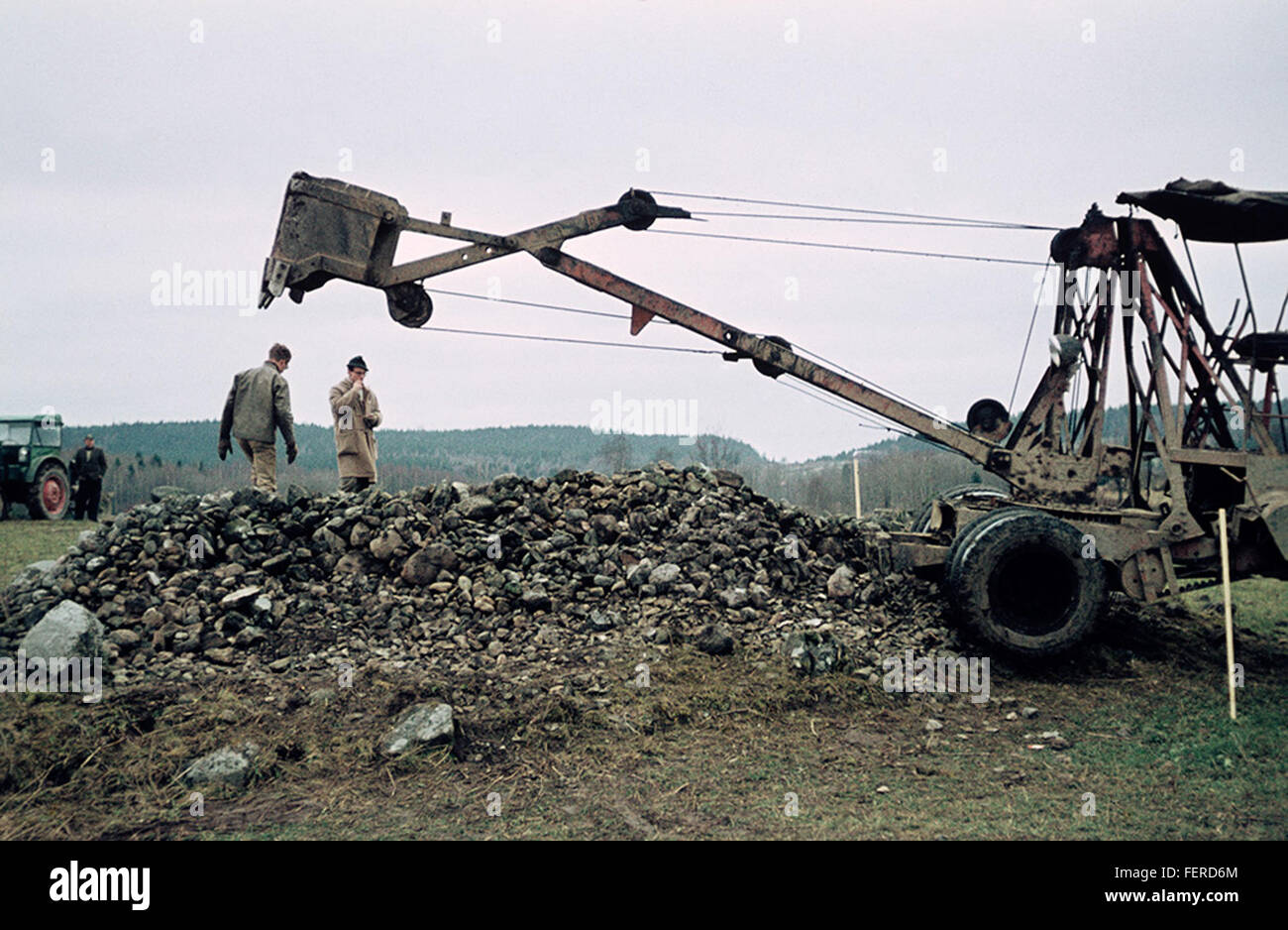 An excavator working at an archaeological excavation site in Håggum ...