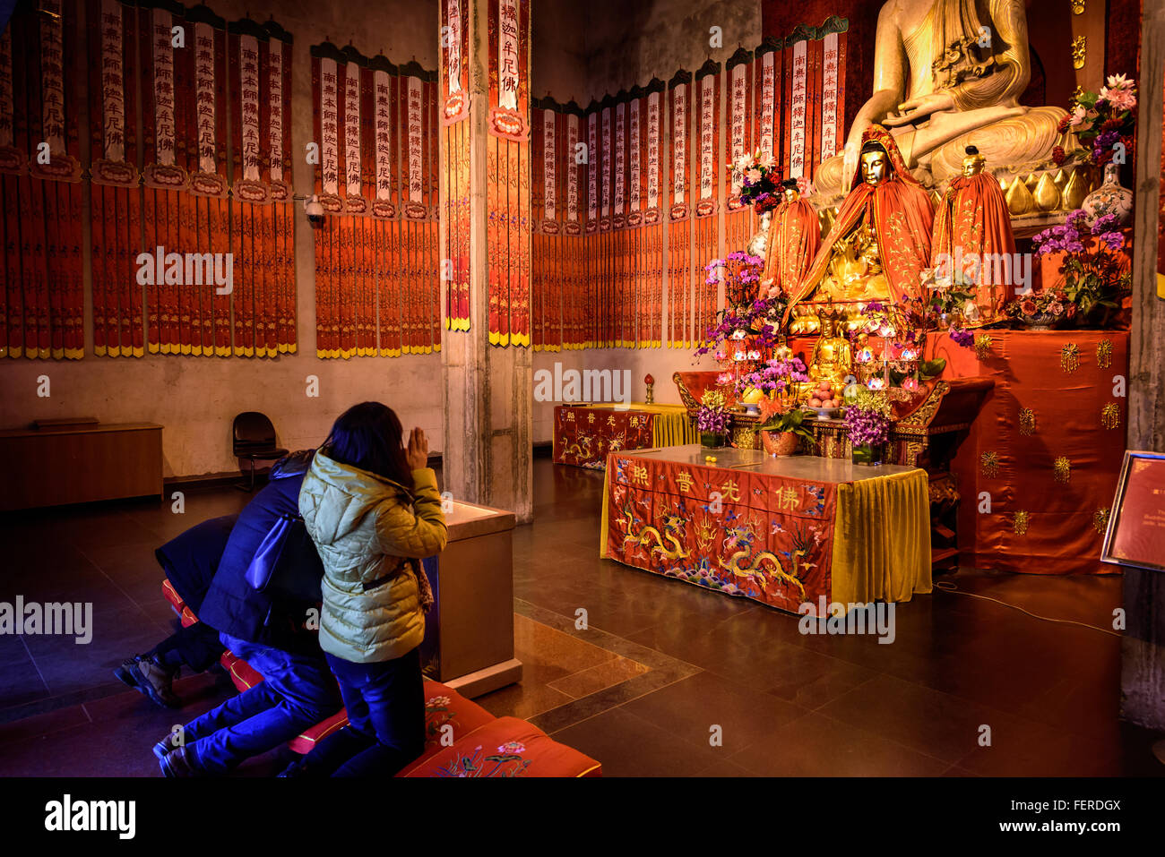 A man and woman praying in the temple, in Shanghai, China Stock Photo ...