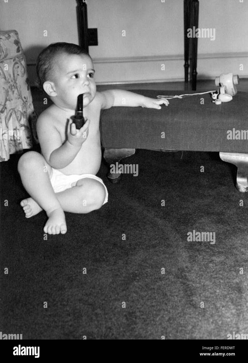 Baby with a pipe Stock Photo - Alamy