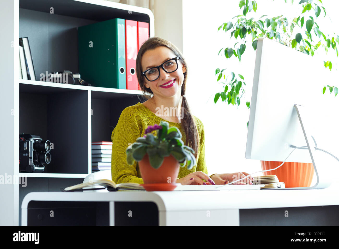 Beautiful young woman working from home - modern business concept Stock ...