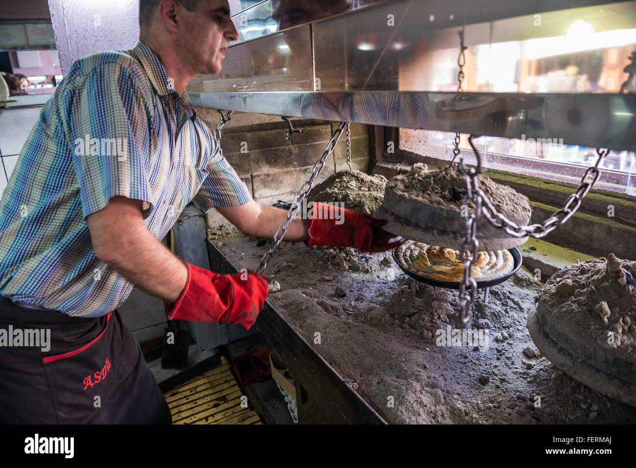 man preparing rolled burek dish in restaurant in Sarajevo, Bosnia and ...