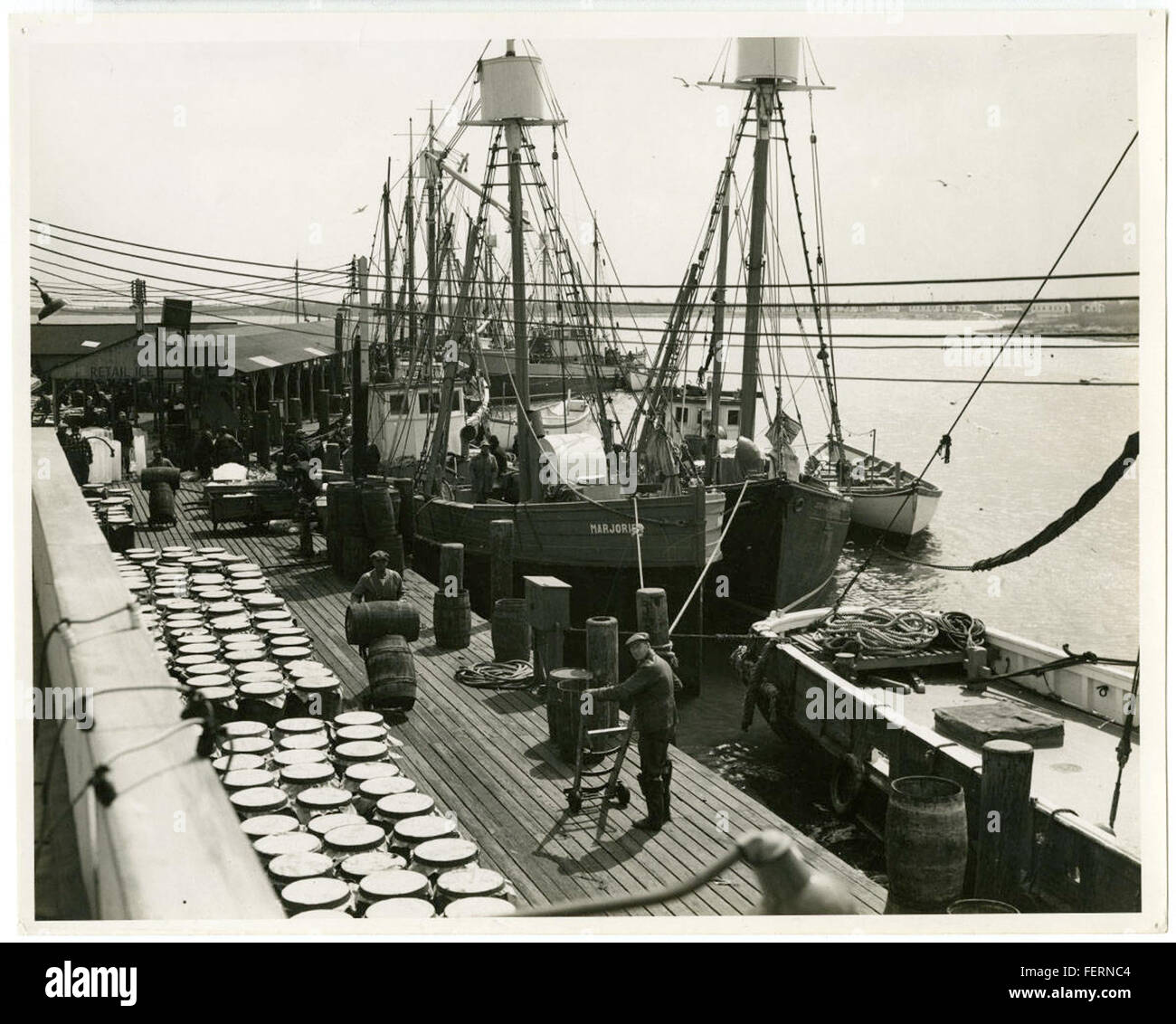 Dock workers transporting ice on a pier in Philadelphia Dock workers ...