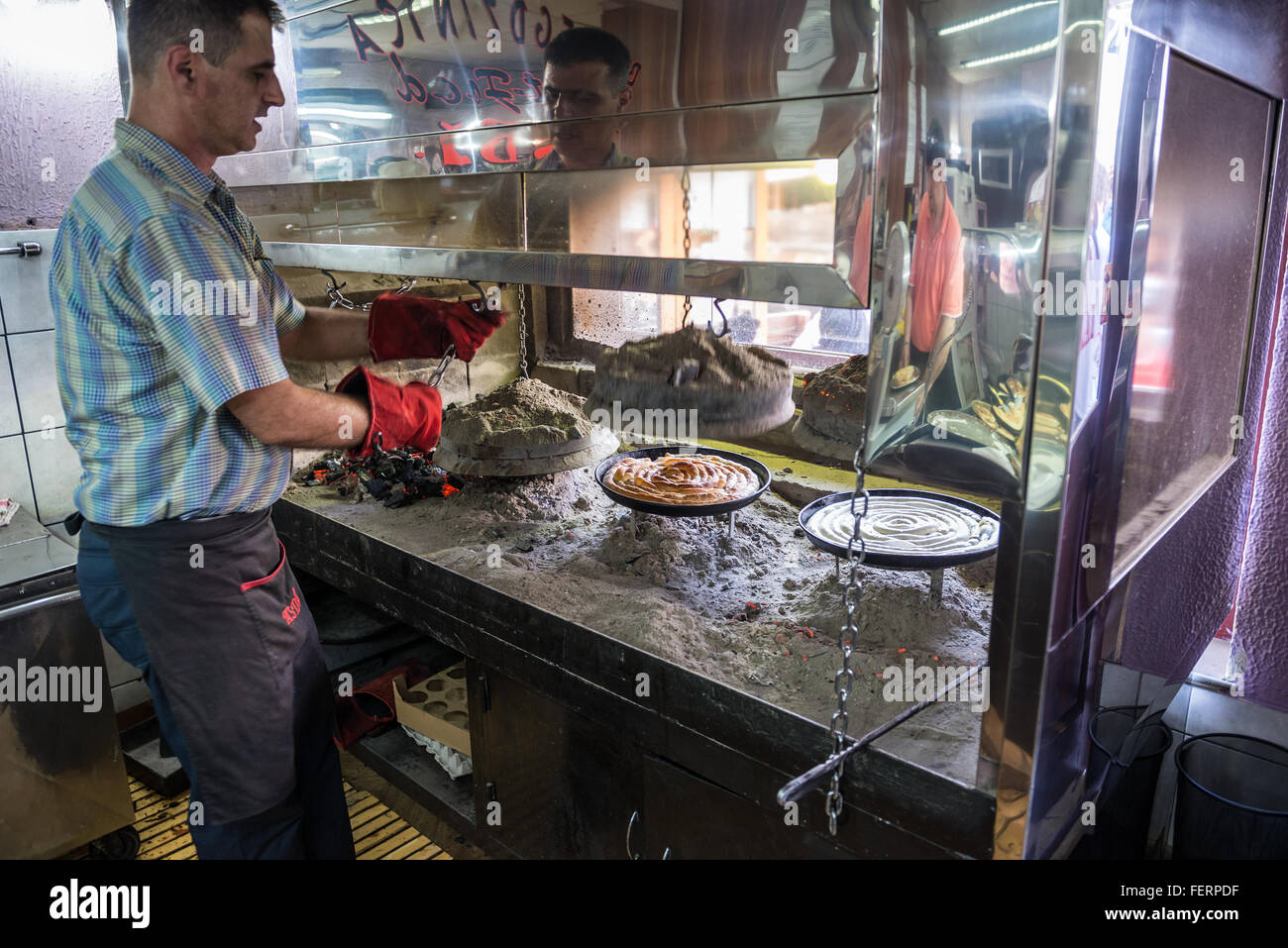 man preparing rolled burek dish in restaurant in Sarajevo, Bosnia and ...