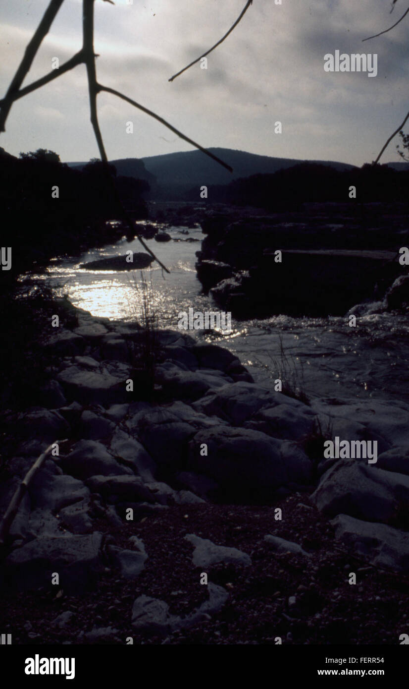 A photograph of Dolan Creek, a serene waterway in a rural setting. The ...