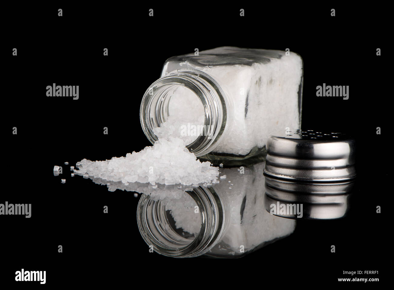 Salt shaker on black Background Stock Photo - Alamy
