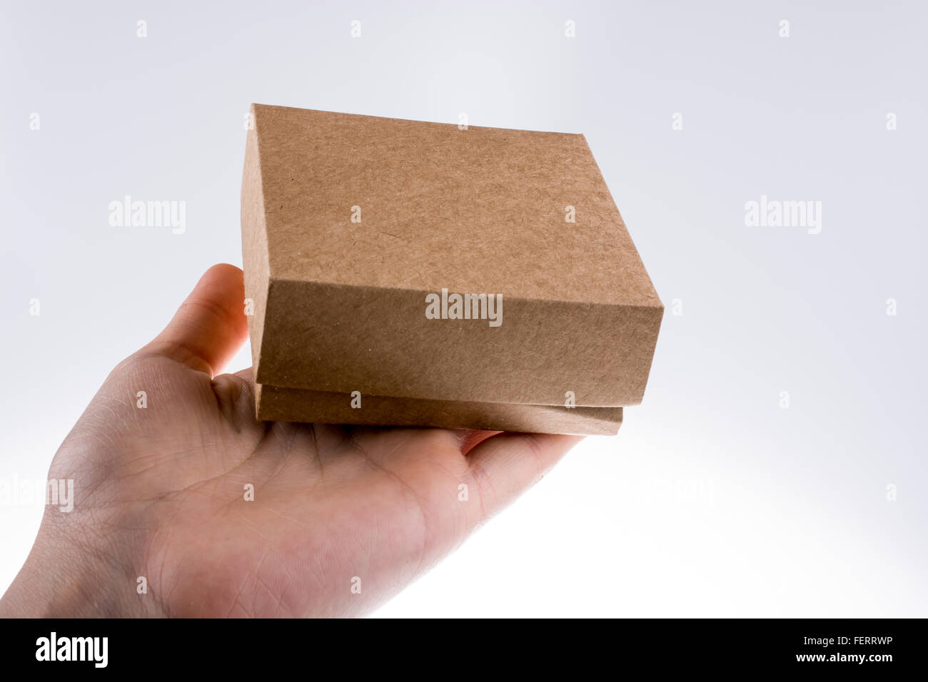 Hand holding cardboard Box on a white background Stock Photo - Alamy