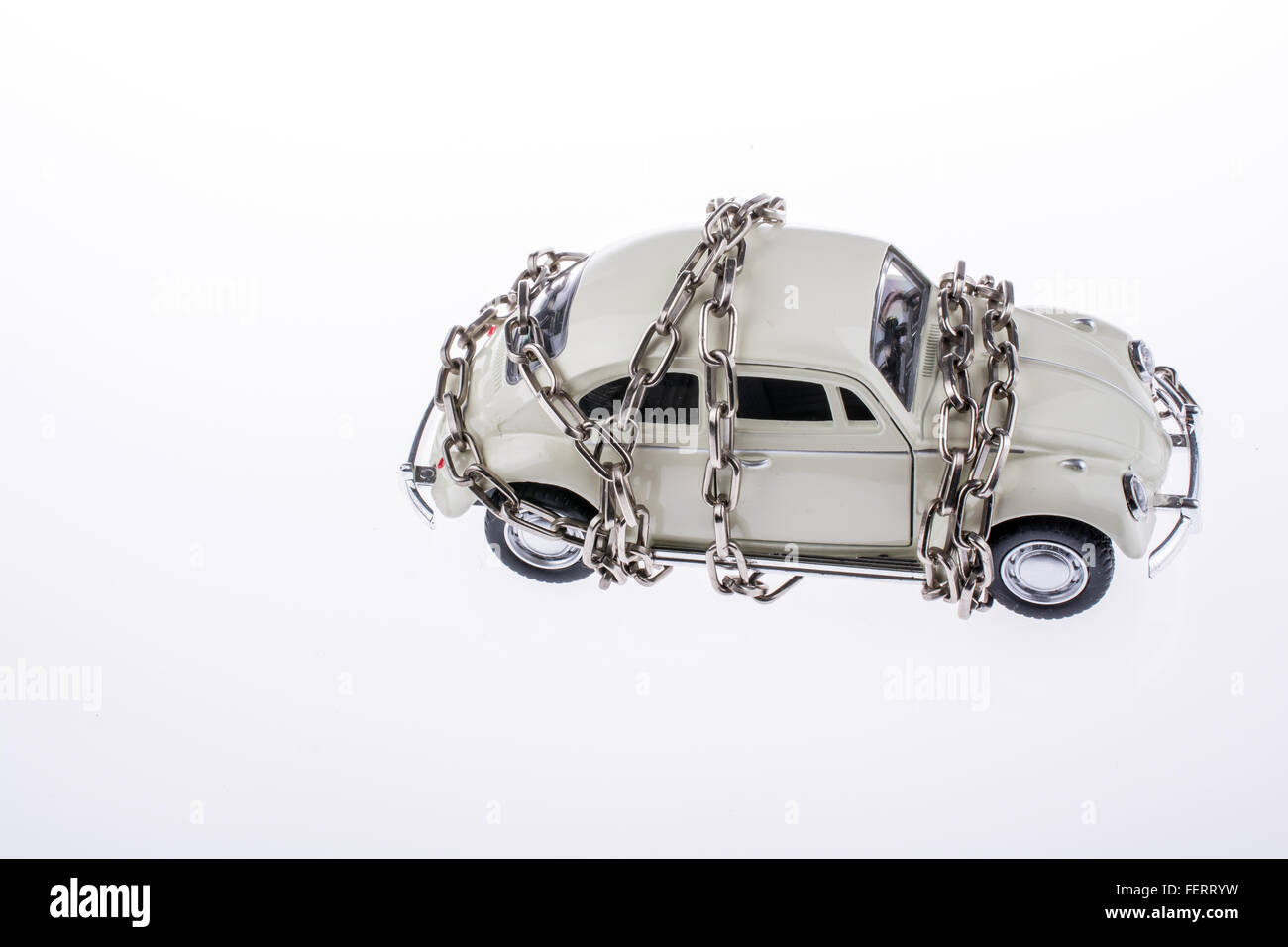 Chained white car on white background Stock Photo - Alamy