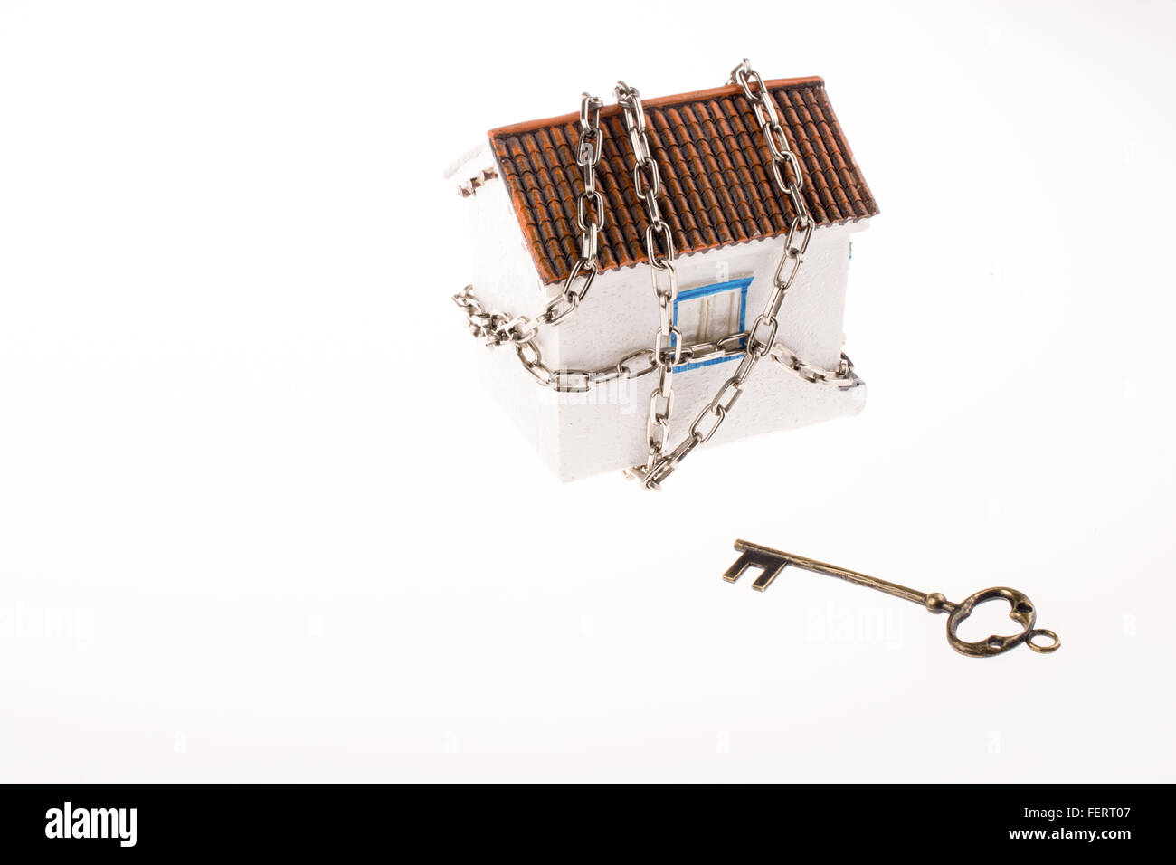 key and a house in chains on a white background Stock Photo - Alamy