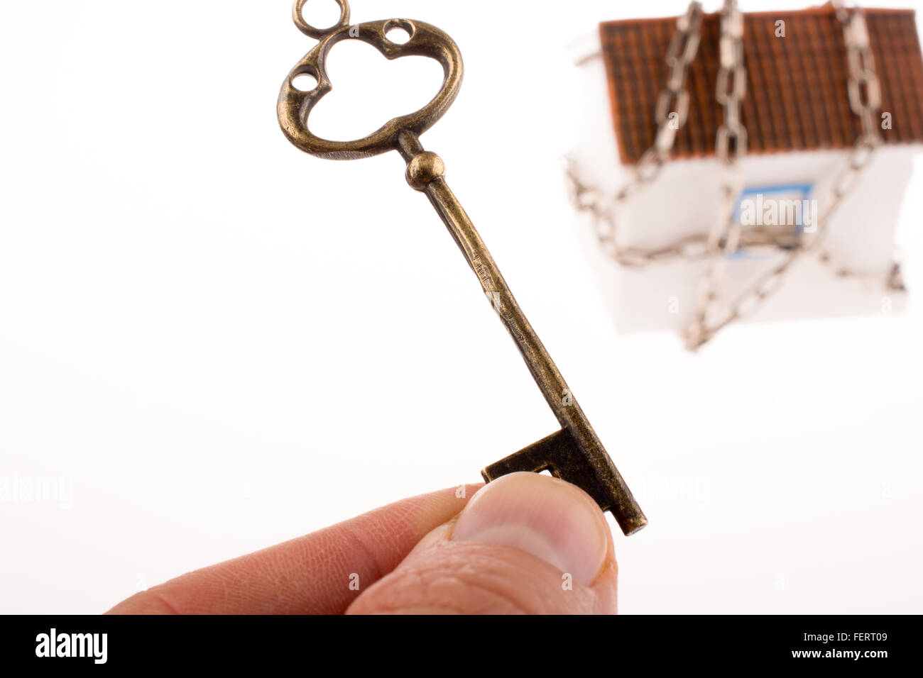 key and a house in chains on a white background Stock Photo - Alamy