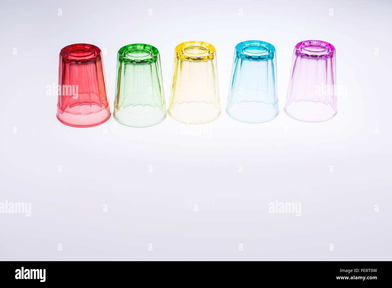 Colorful drinking glasses on white background Stock Photo - Alamy