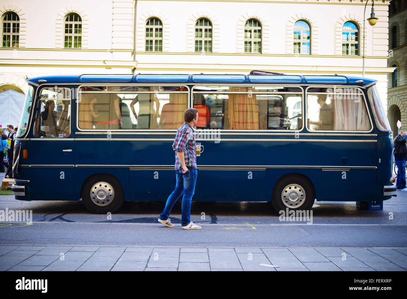 Full Length Side View Of Man Standing By Bus On Street Stock Photo - Alamy