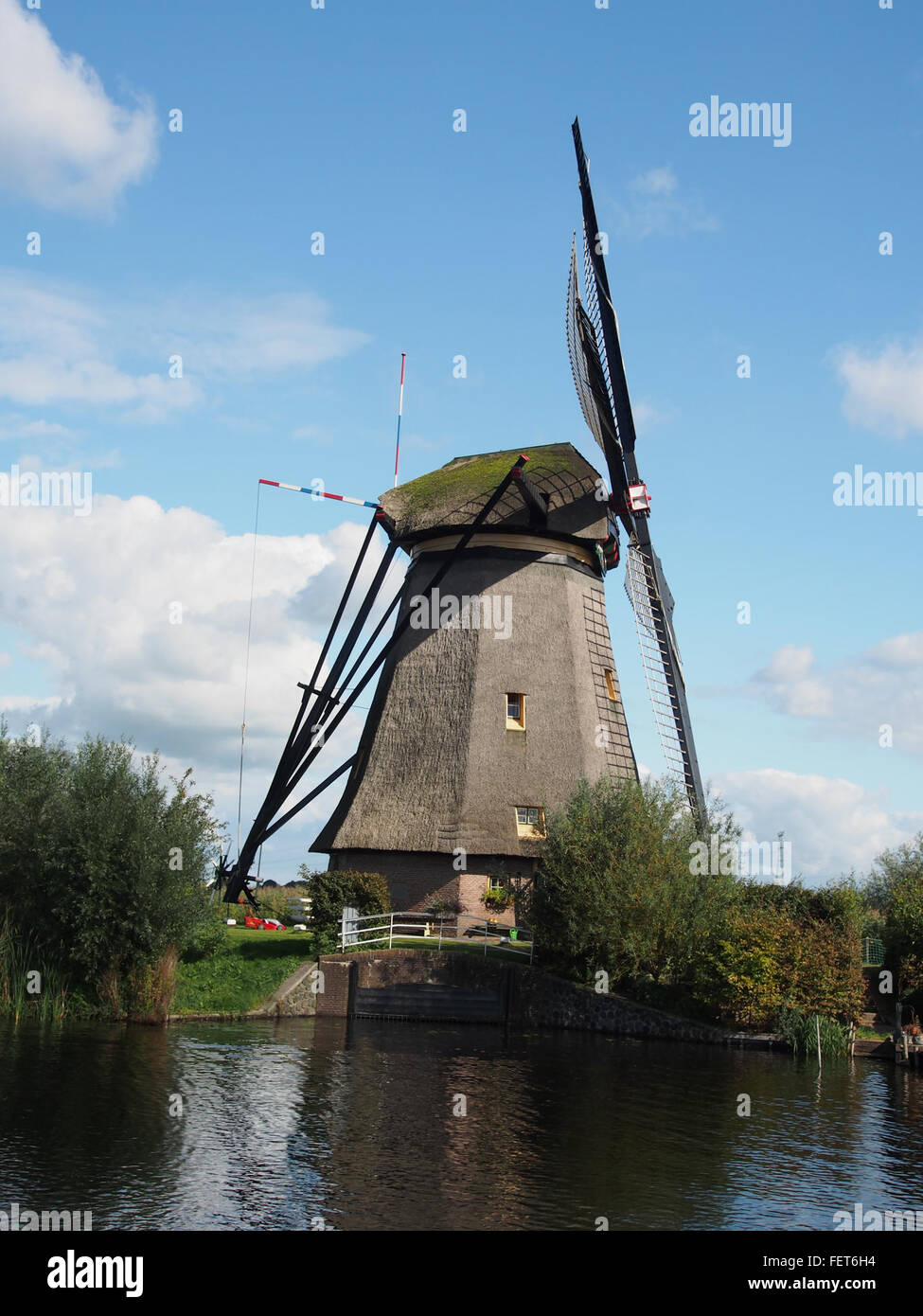 A traditional Dutch windmill stands tall at Kinderdijk, Netherlands ...