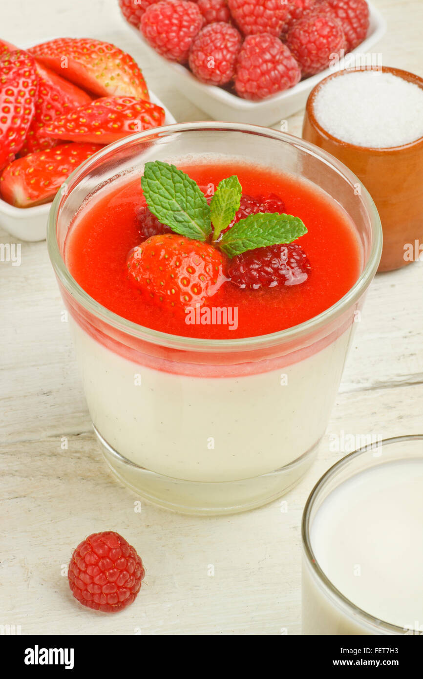 White chocolate panna cotta with some ingredients on white background ...