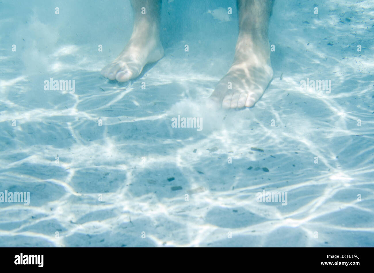 Male feet details underwater in the sea on the sand Stock Photo - Alamy
