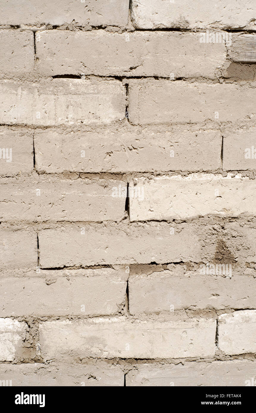 Texture of a wall made of mud bricks. Some parts are wet. Construction ...