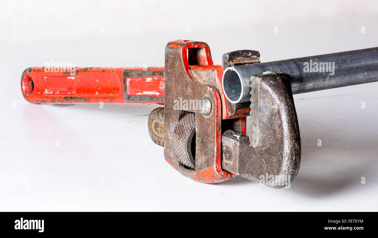 Pipe wrench with a the jaws holding one Stock Photo - Alamy