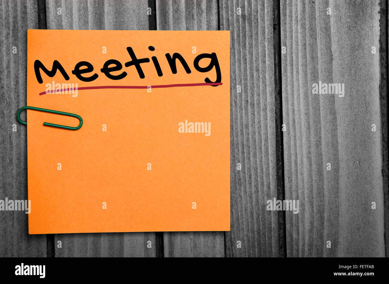 Meeting word on orange notes Stock Photo - Alamy