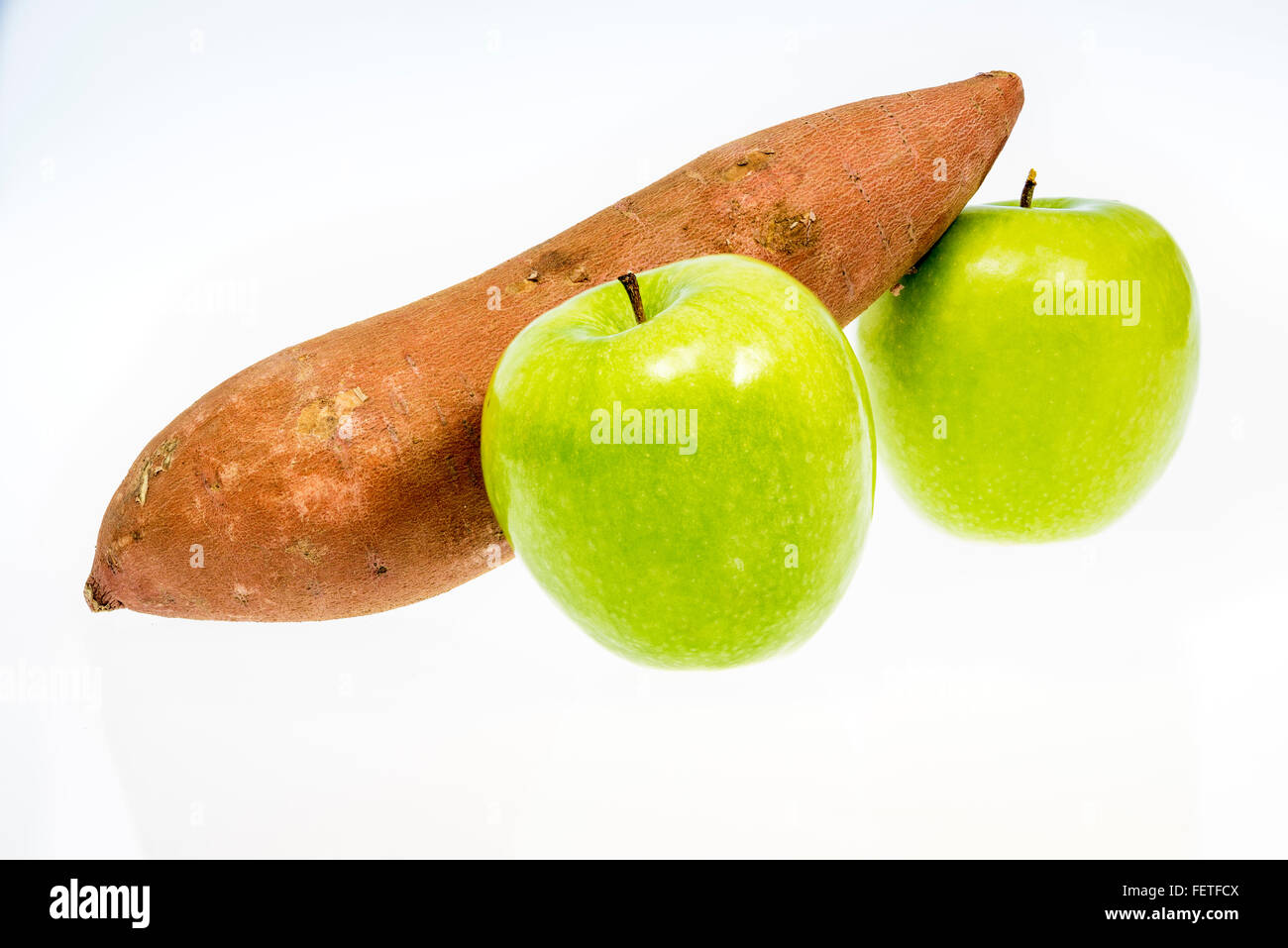 Two green apples and Yam in the same picture Stock Photo - Alamy