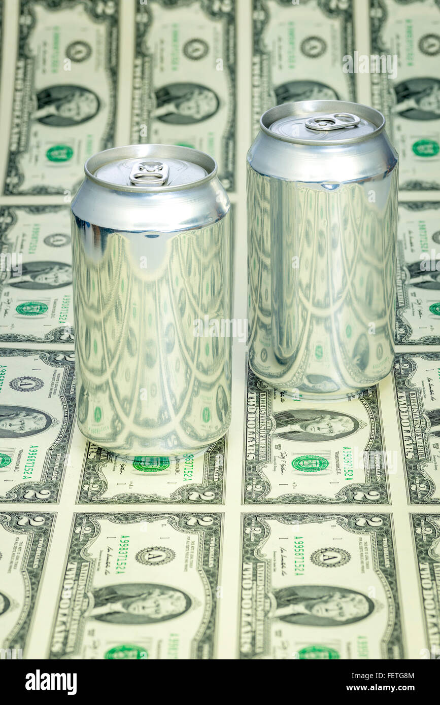Two Aluminum cans on an uncut sheet of dollars Stock Photo - Alamy