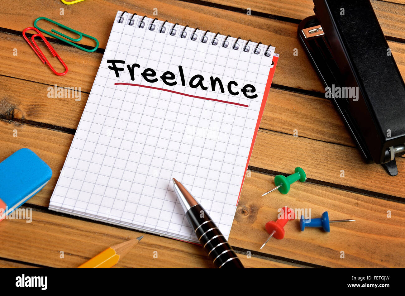 Freelance word on notepad closeup Stock Photo - Alamy