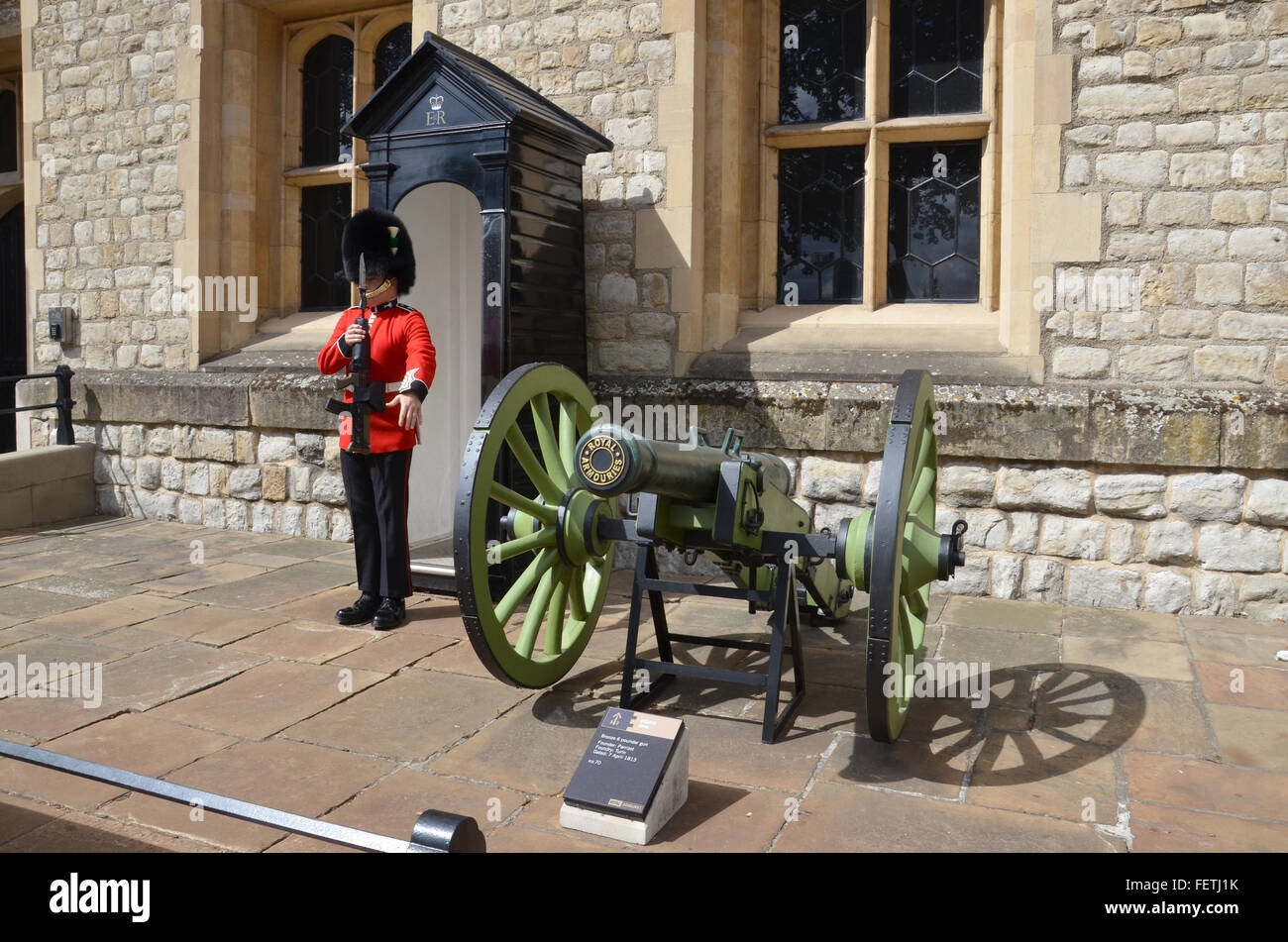 LONDON - AUGUST 6: A beefeater stands guard at the Tower of London on ...