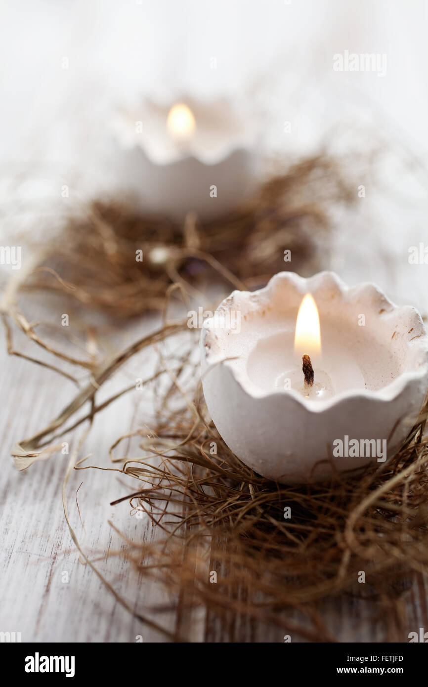 Easter egg shell candles on top of nest Stock Photo - Alamy