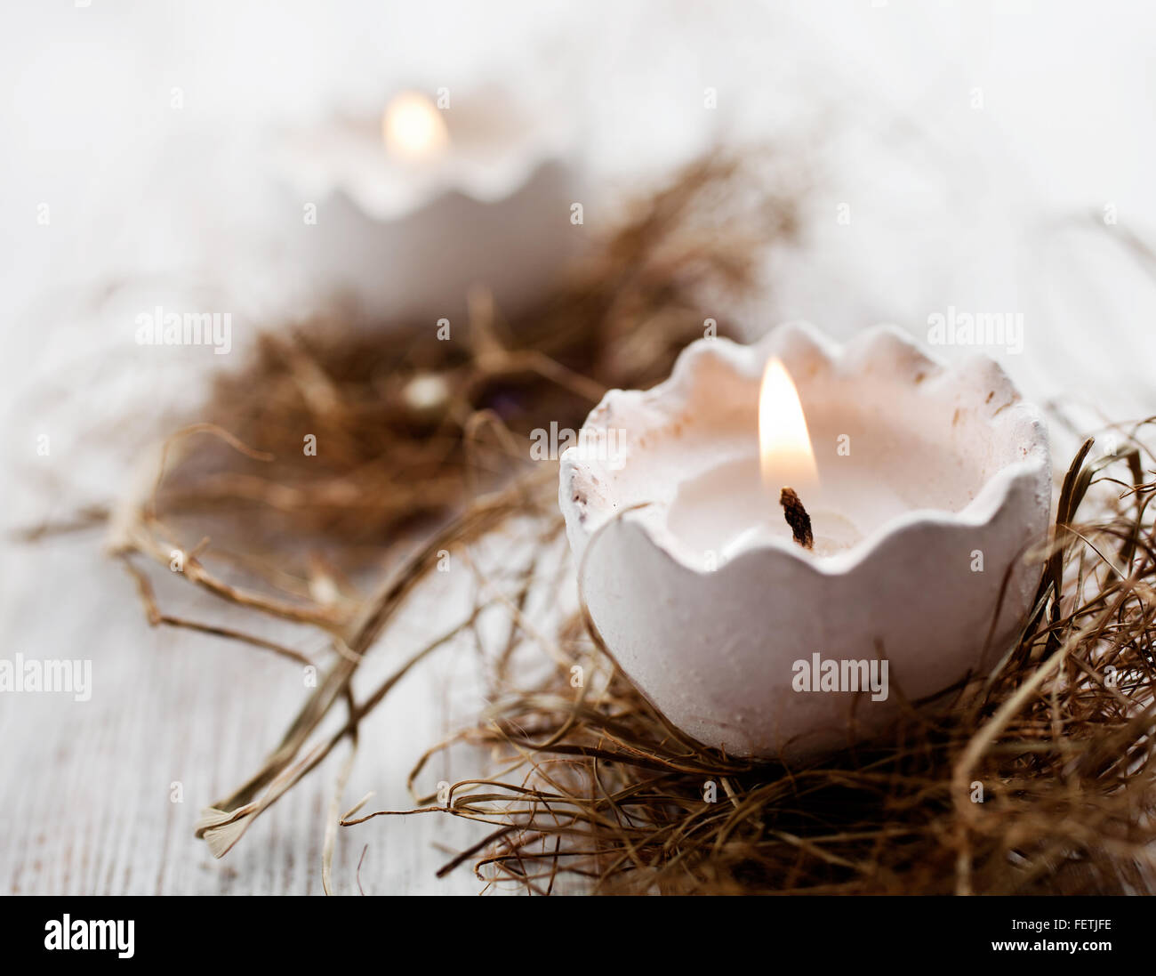 Easter egg shell candles on top of nest Stock Photo - Alamy