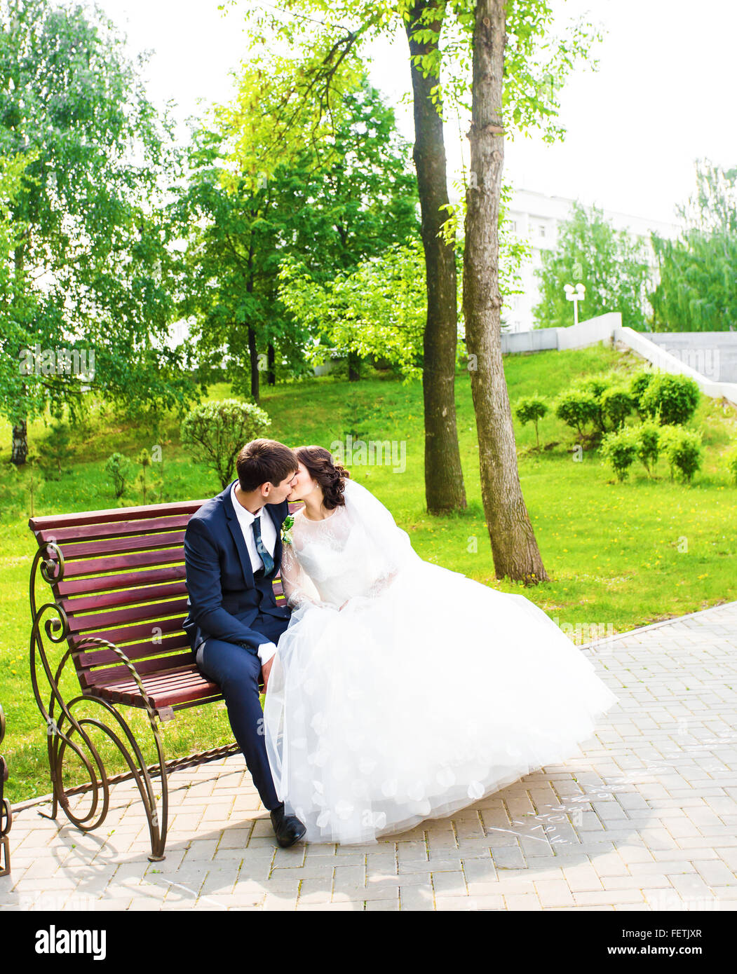 Beautiful wedding couple in park. They kiss and hug each other Stock ...