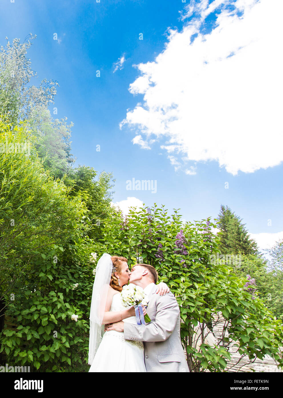 Beautiful wedding couple in park. They kiss and hug each other Stock ...