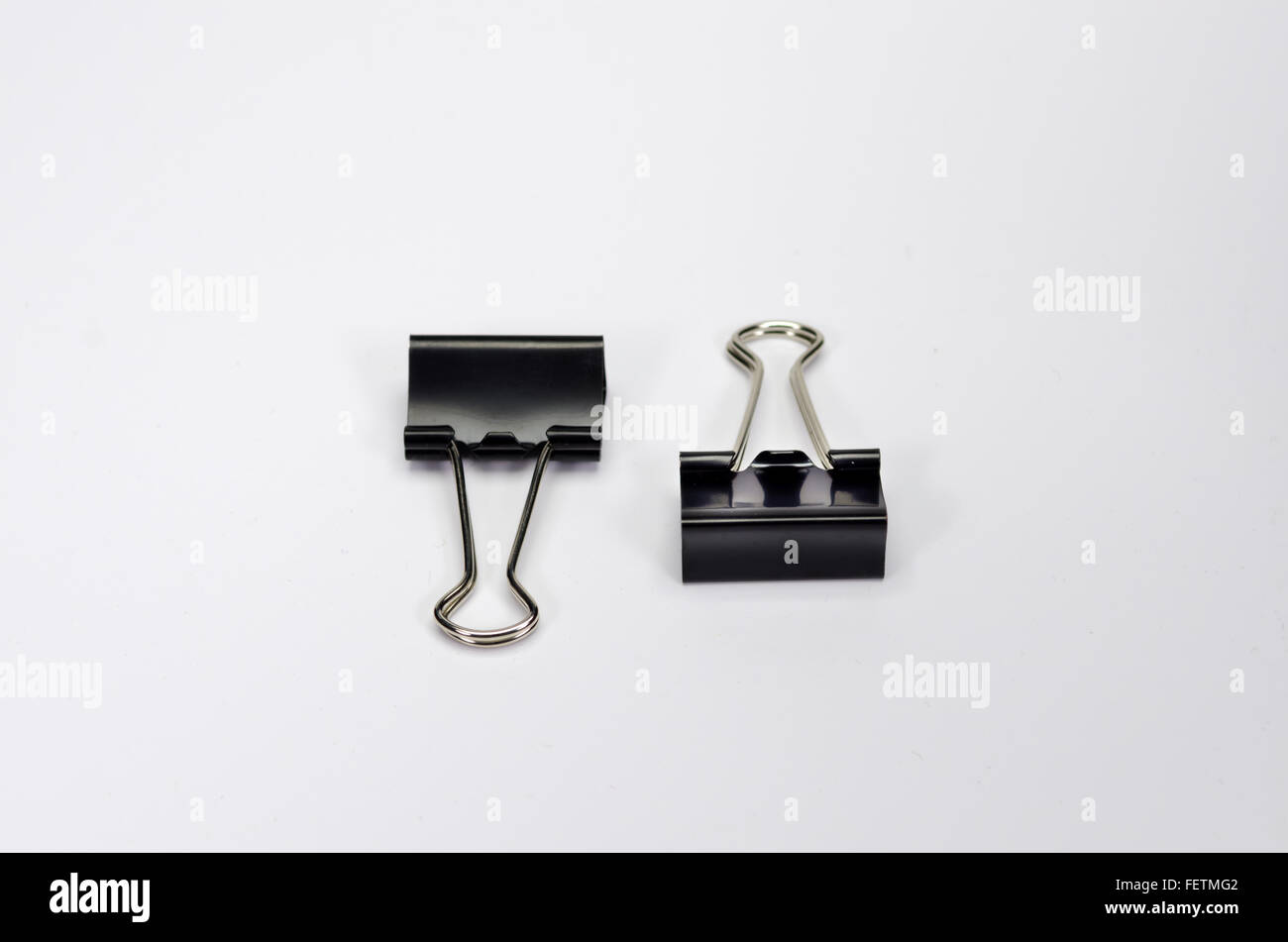 Black paper clip isolated on white background Stock Photo - Alamy