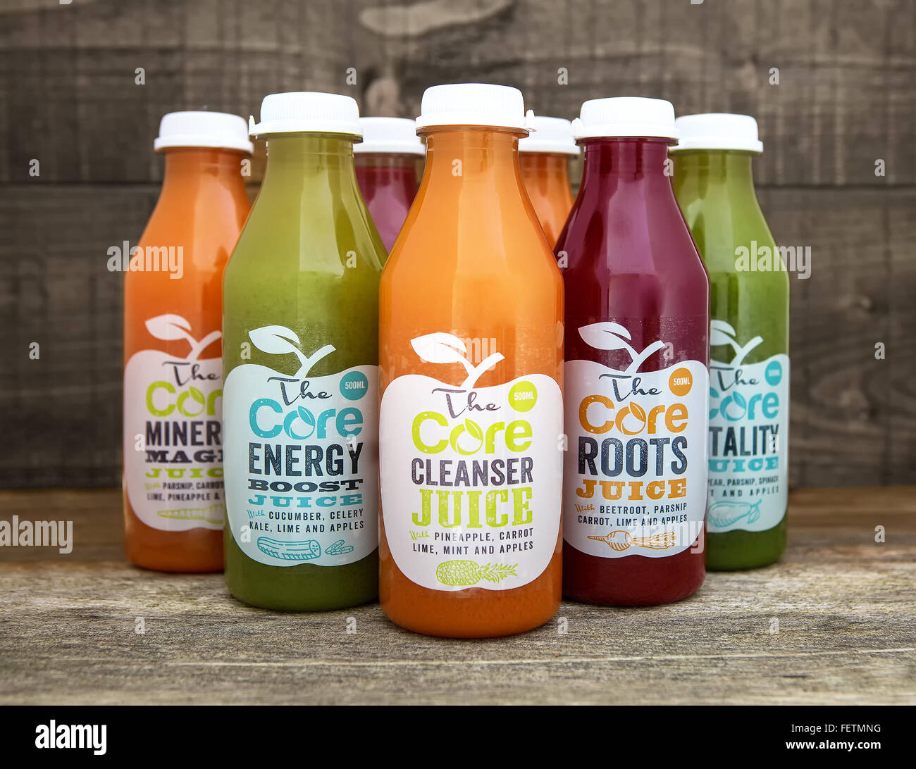The Core Juice Bottles on a wooden background Stock Photo - Alamy