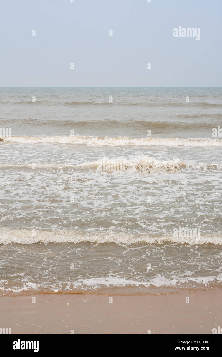 Incoming high frothy and foamy sea waves on a tropical beach in the ...