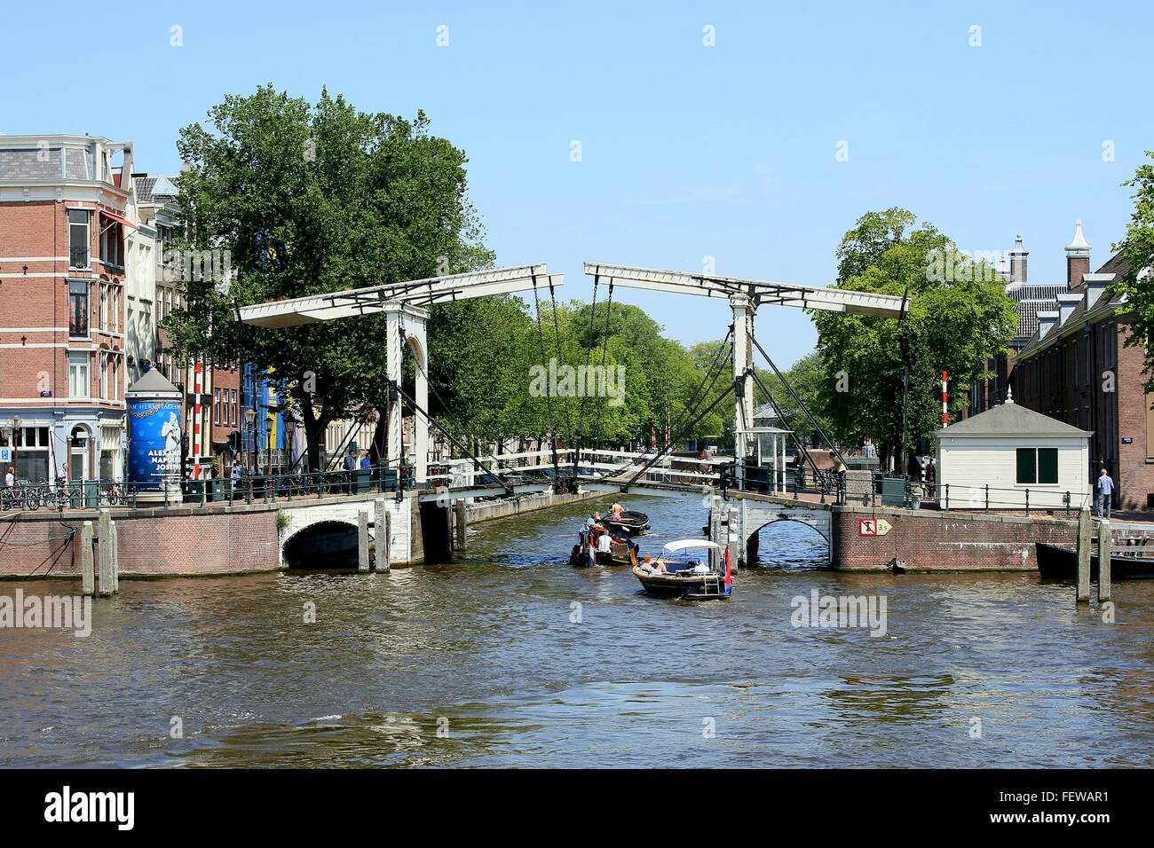 Old white wooden drawbridge where Amstel river meets Nieuwe Herengracht ...