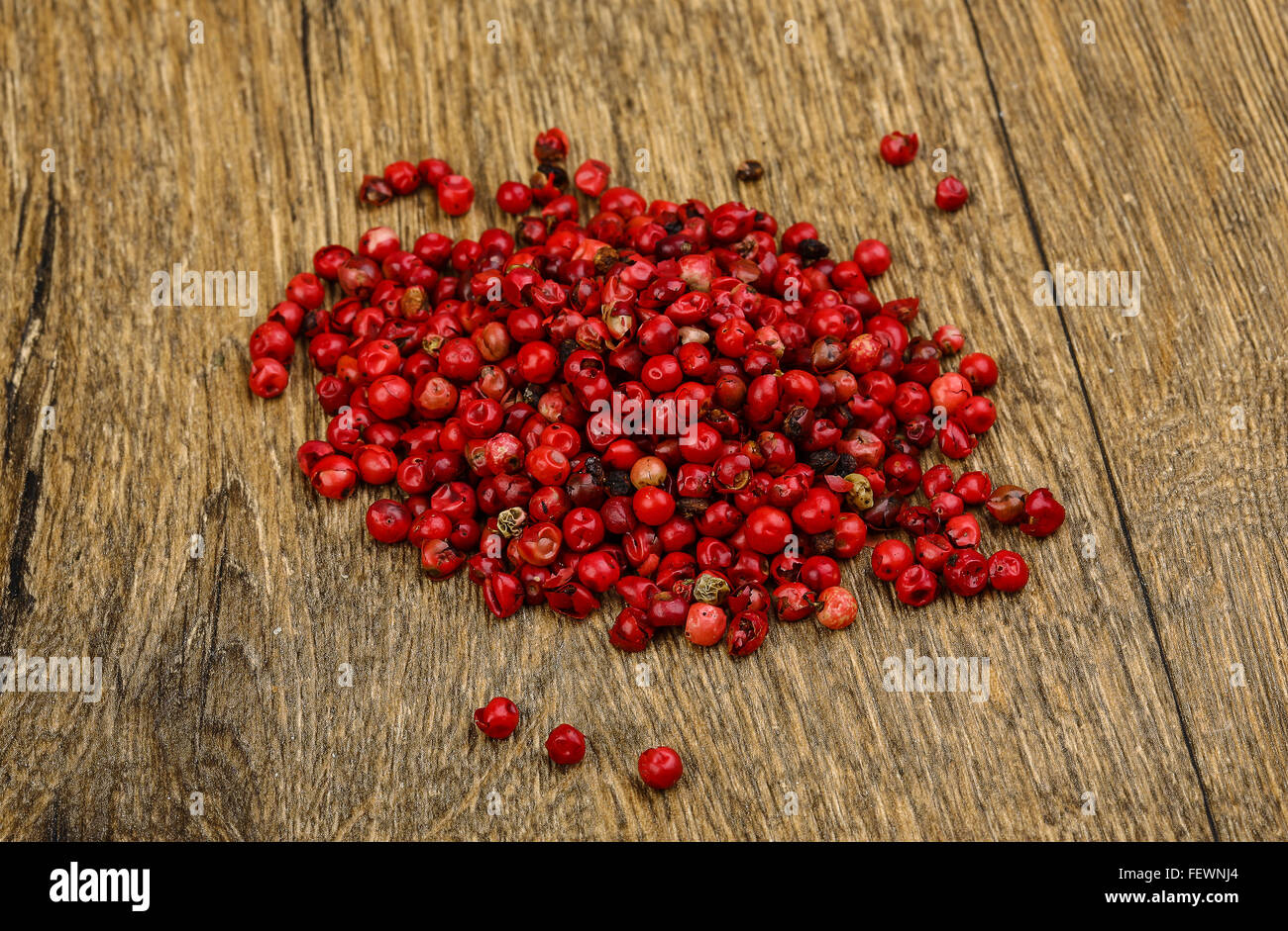 Dry Rose pepper corn on the wood background Stock Photo - Alamy