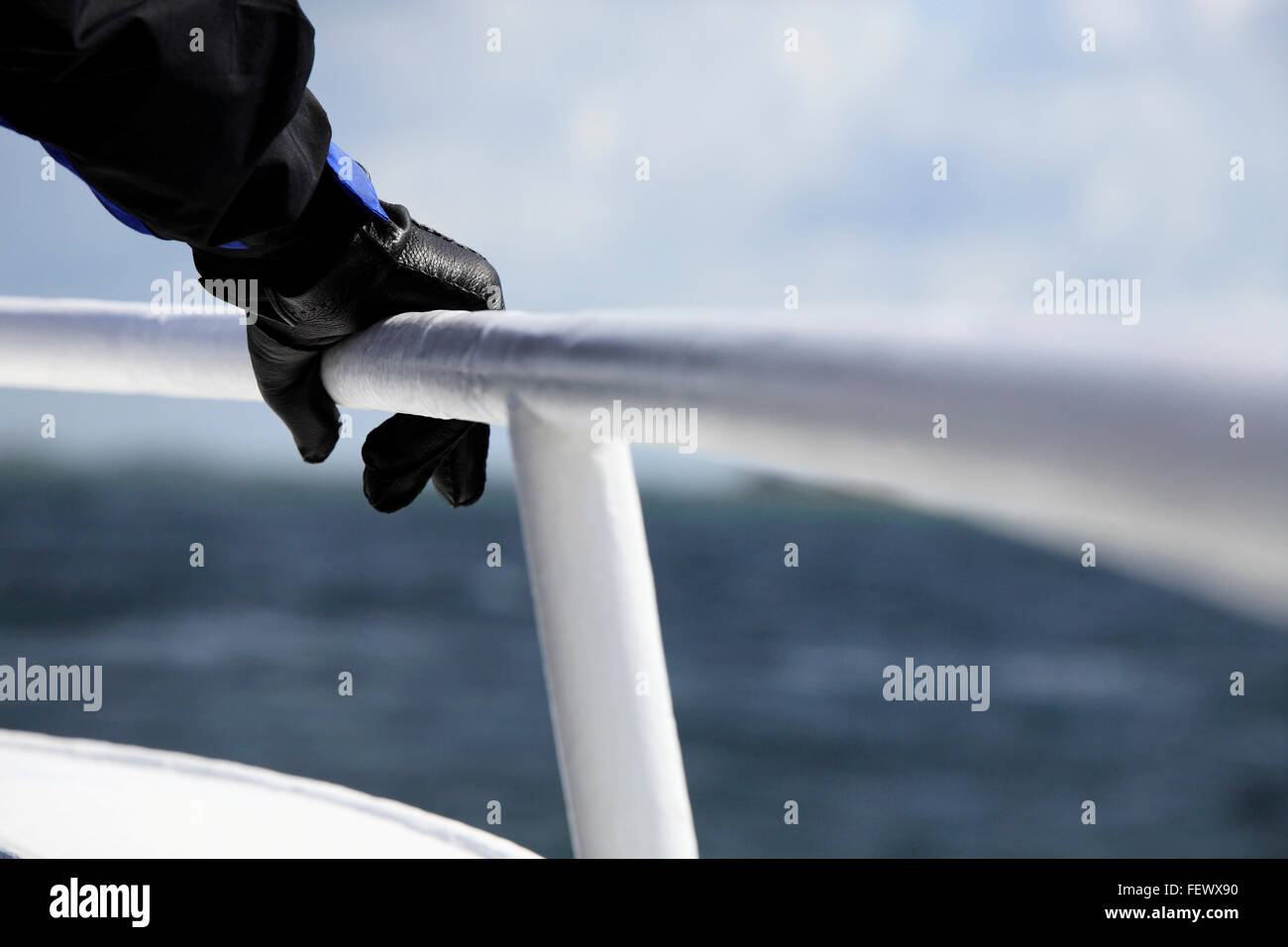 Hand Wearing a Black Leather Glove Holding onto a White Hand Rail on a ...