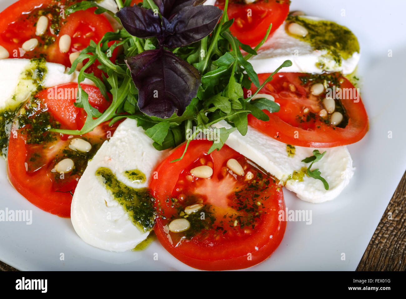 Italian traditional Caprese salad with cedar nuts Stock Photo - Alamy