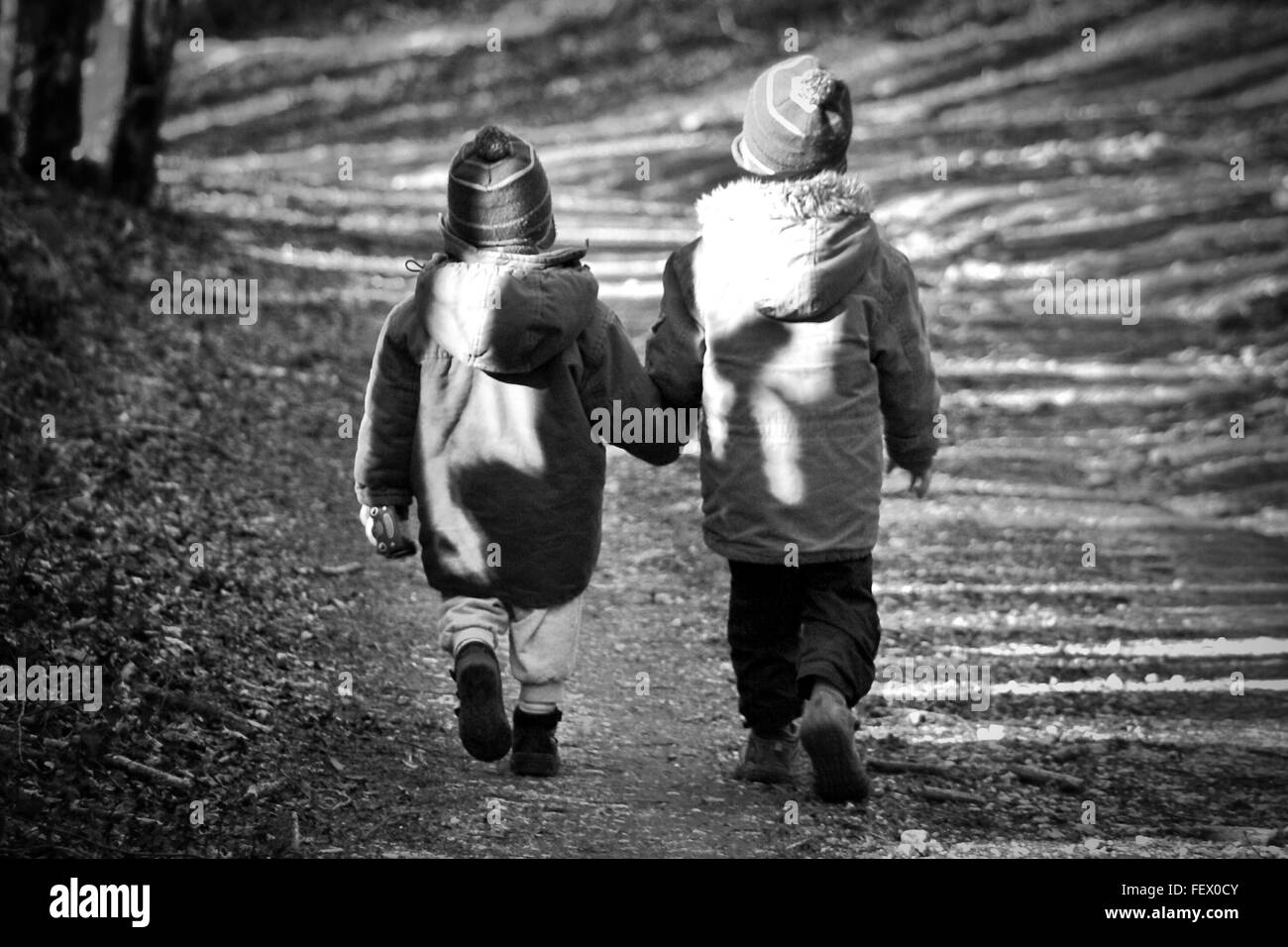Rear View Of Boys Walking On Street Stock Photo - Alamy