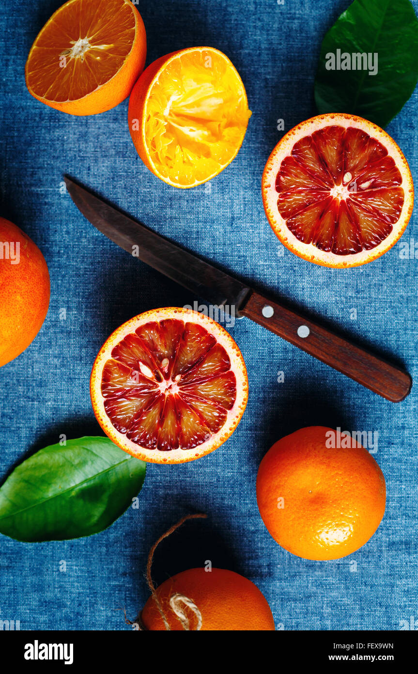Different Sorts of Ripe Juicy Orange Fruits on Blue Textile background ...