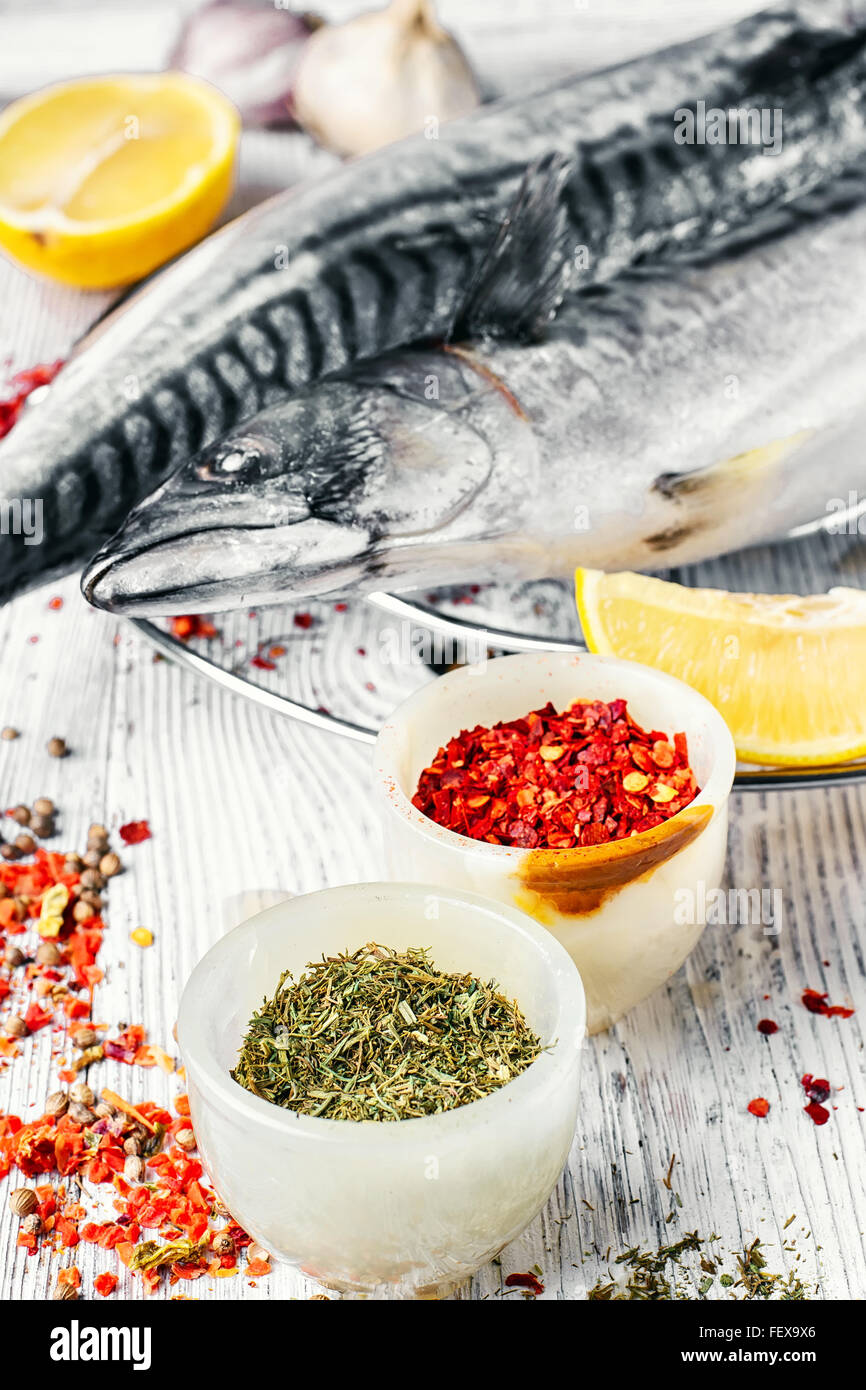 Thawed fresh fish mackerel with spices and marinade with lemon ...