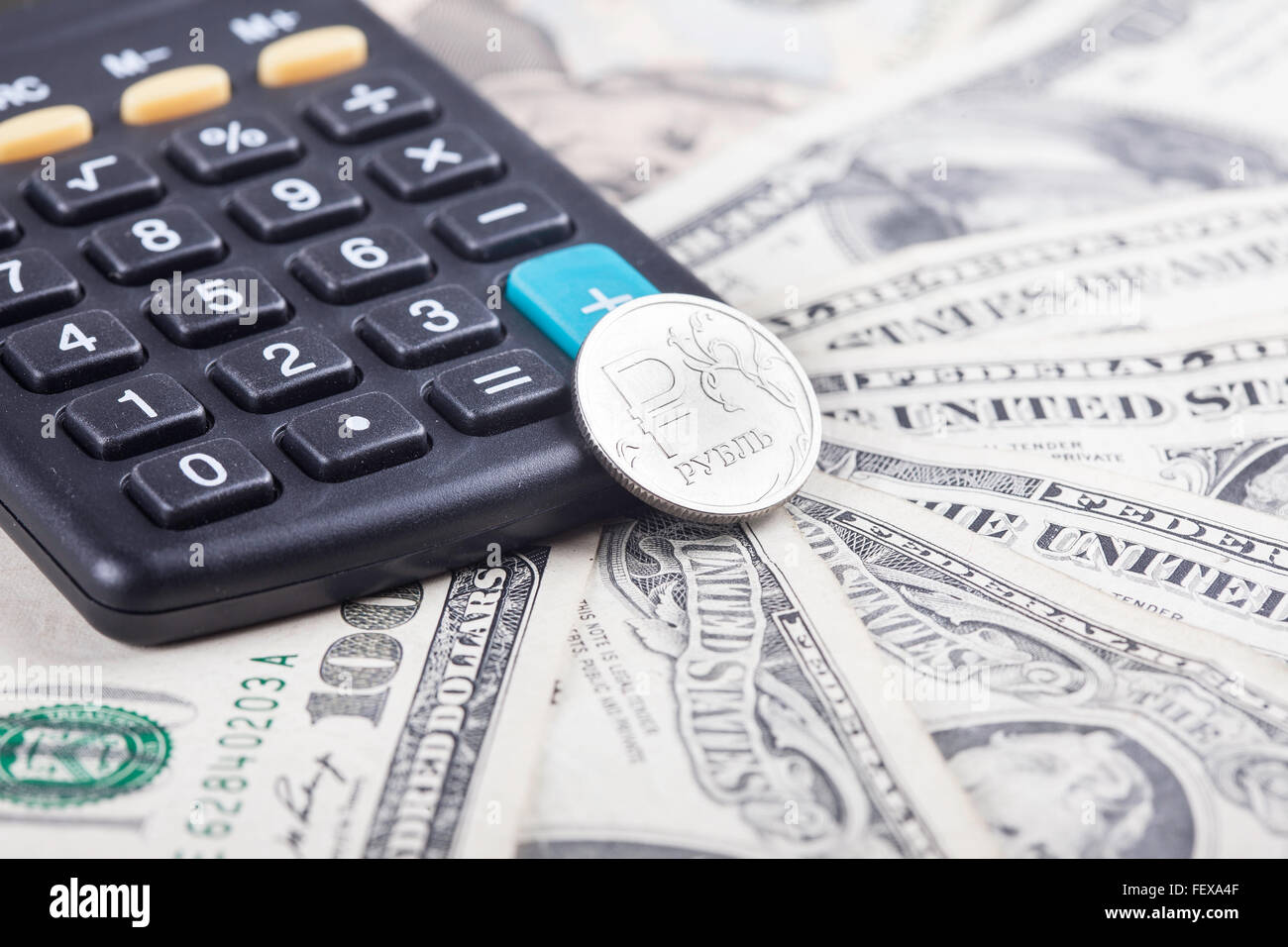 calculator and coin ruble on the background of dollars Stock Photo - Alamy