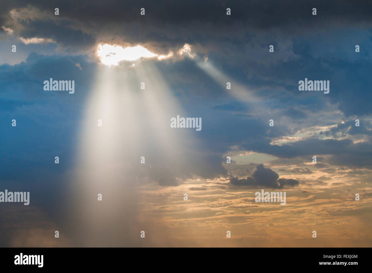 sun ray light through down from rain cloud during sunset time Stock ...