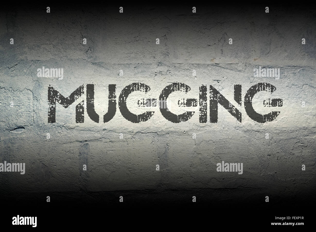 mugging stencil print on the grunge white brick wall Stock Photo - Alamy