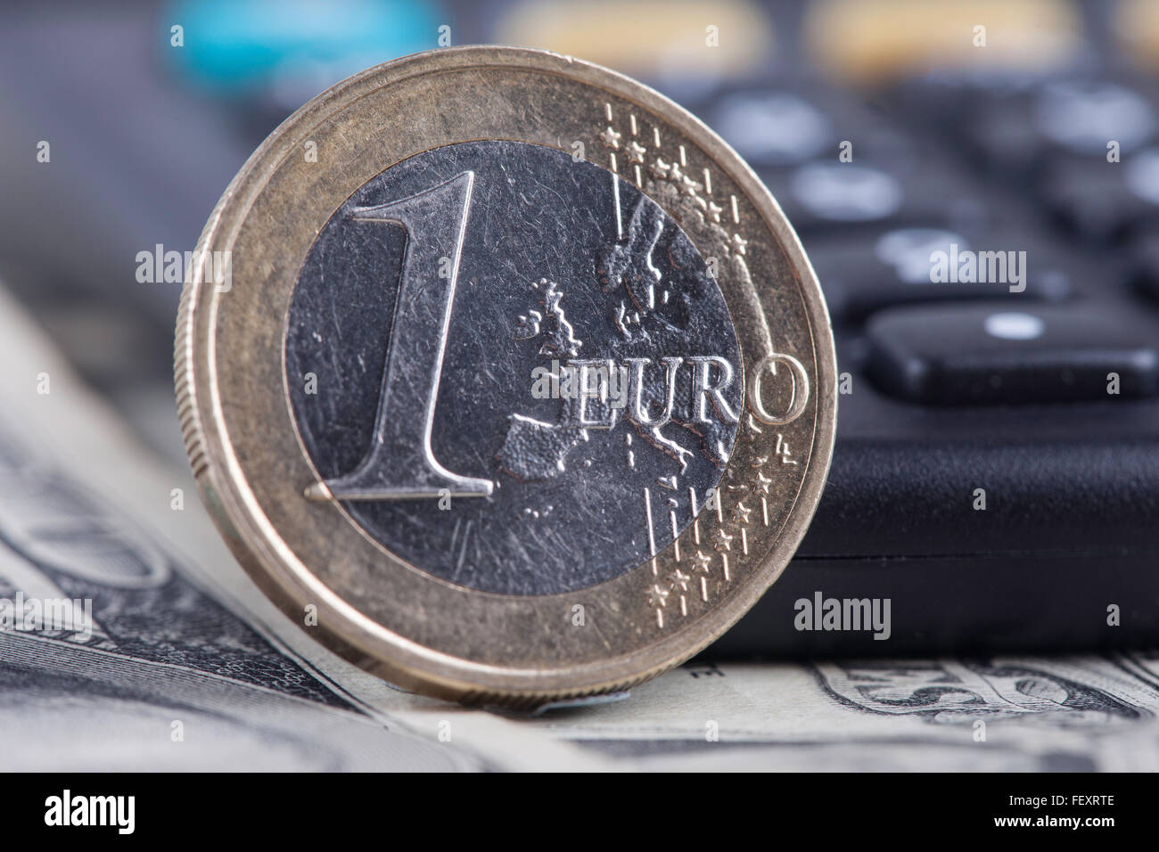 coin euro closeup, calculator on the background of banknotes dollars ...